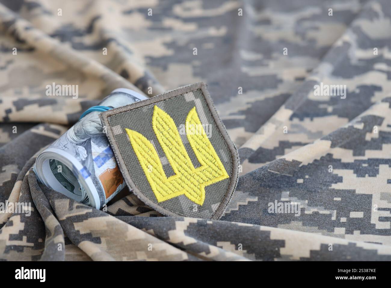 Ukrainian army symbol and bunch of dollar bills on military uniform ...