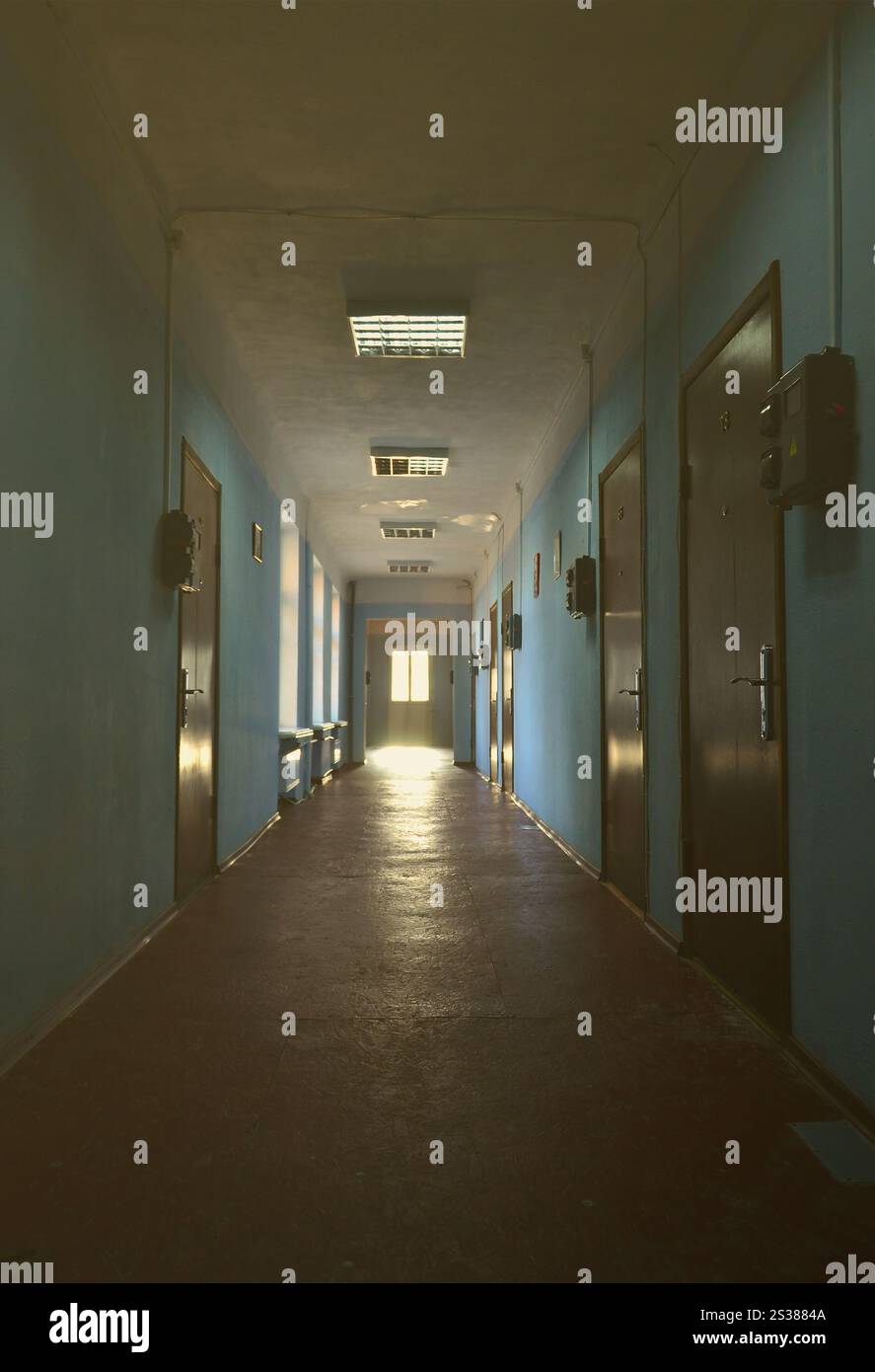 The gloomy corridor of a neglected public building. Public space in a ...