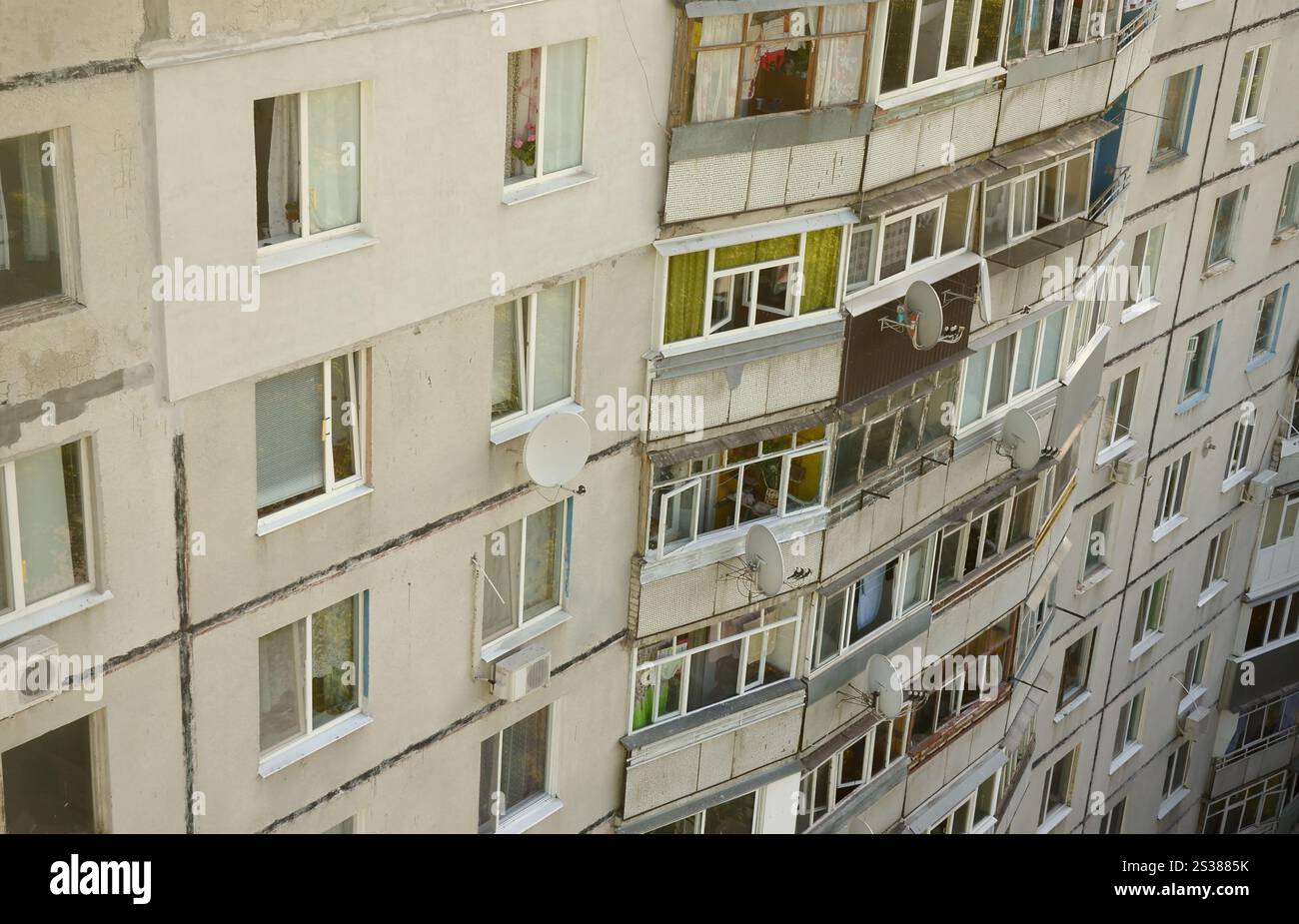 Facade of a grey multi storey soviet panel building. Russian old urban ...