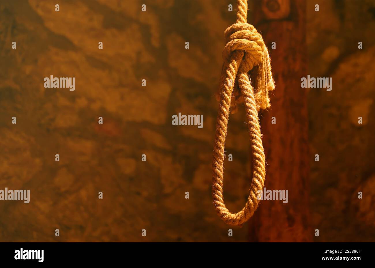 Noose in prison of old castle cellar and grunge stone wall close up ...