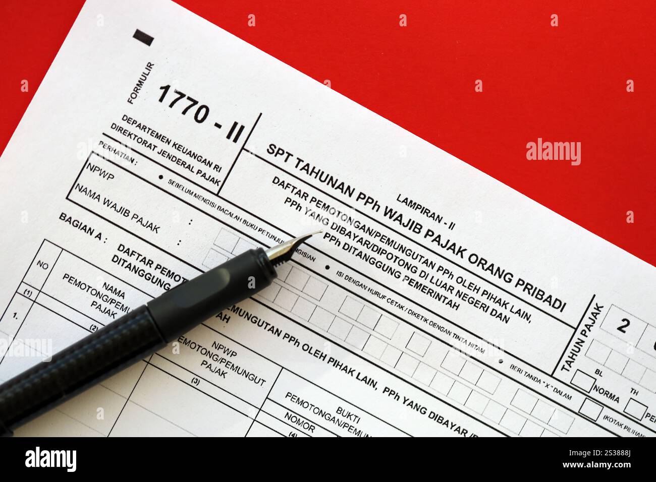 Indonesian tax form 1770-2 Individual Income Tax Return and pen on table close up. Indonesian ...