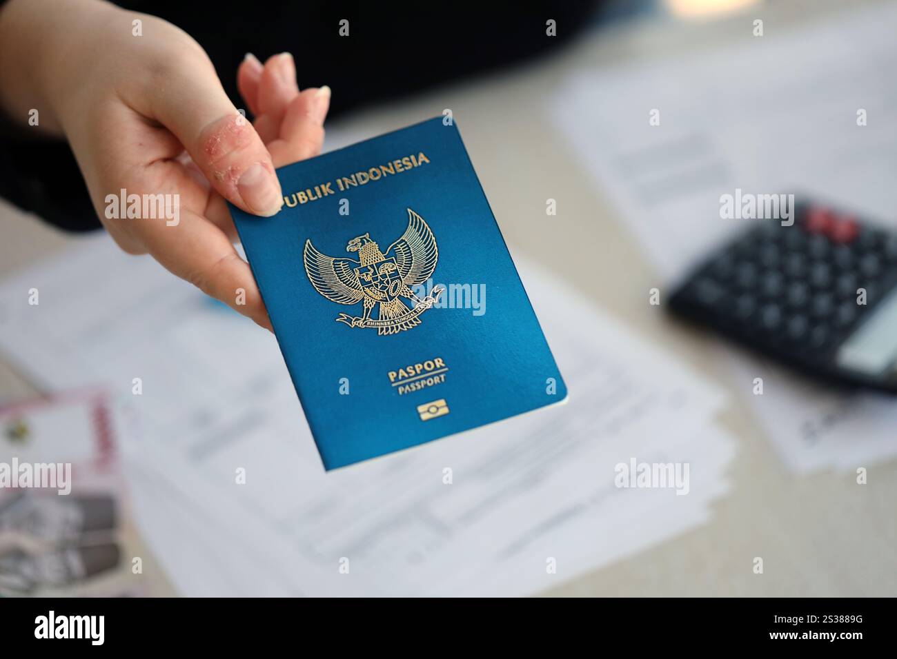 Indonesia passport and service workers table on process of citizenship registration. Female ...