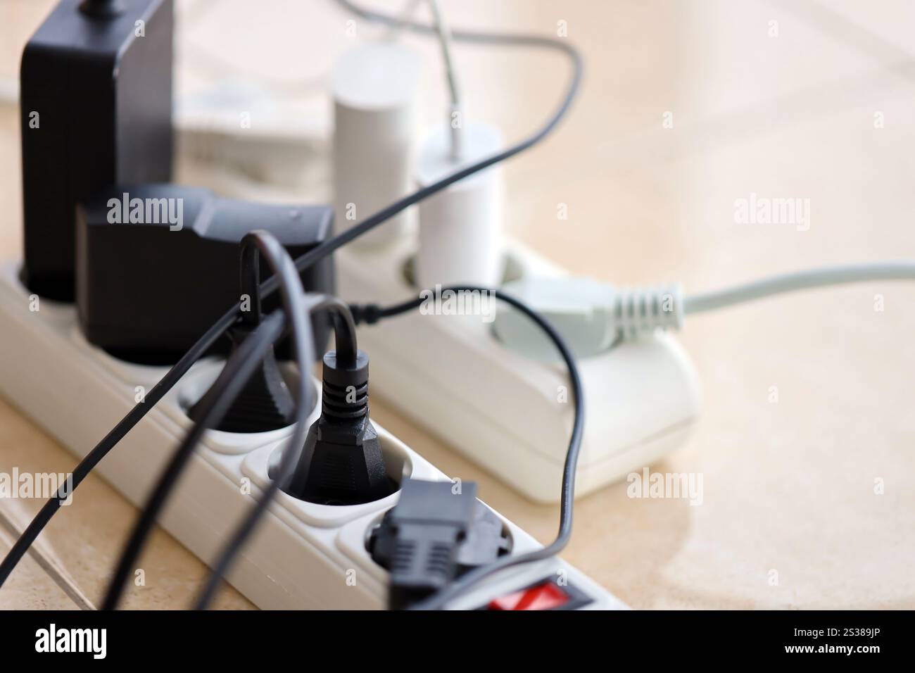 Overloaded power boards. Power strips with different electrical plugs ...