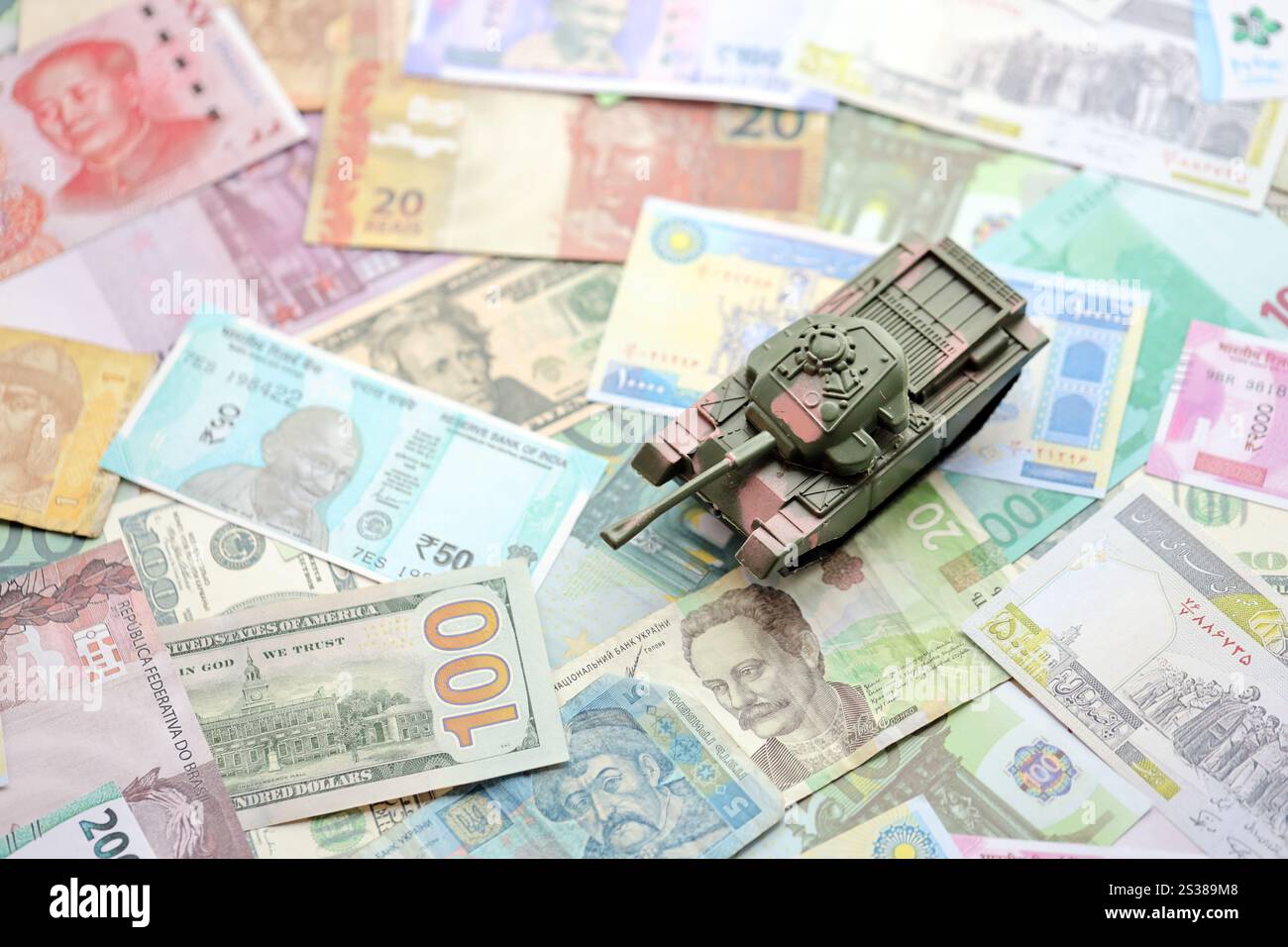 Small green tank on many banknotes of different currency. Background of ...