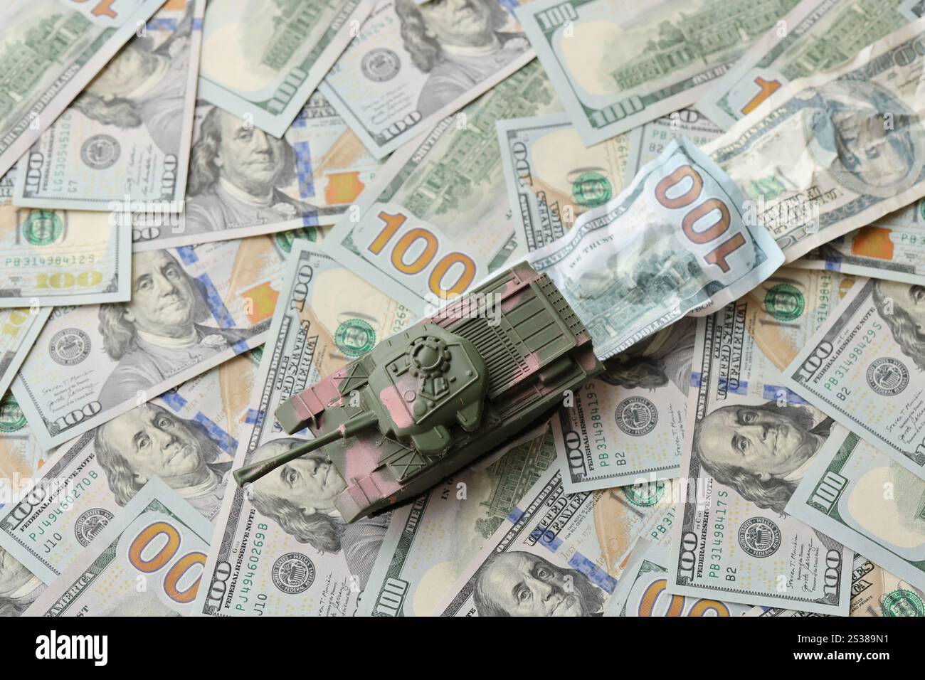 Tank on crumpled hundred dollar bills banknotes. Background of war ...