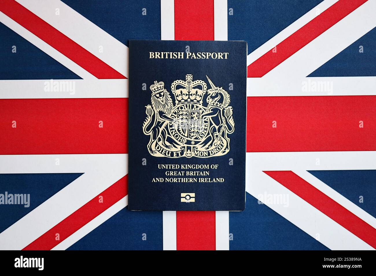 Blue British passport on national flag background close up. Tourism and ...