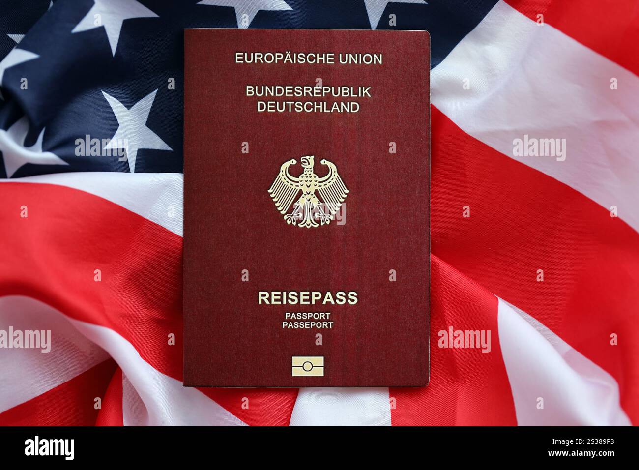 Red German passport of European Union on United States national flag ...
