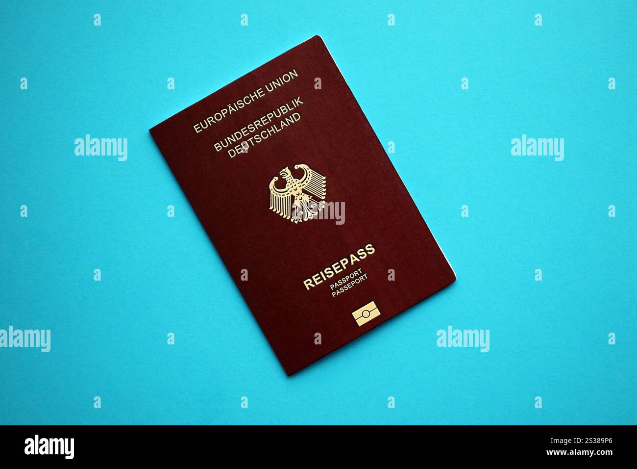 Red German passport of European Union on blue background close up ...