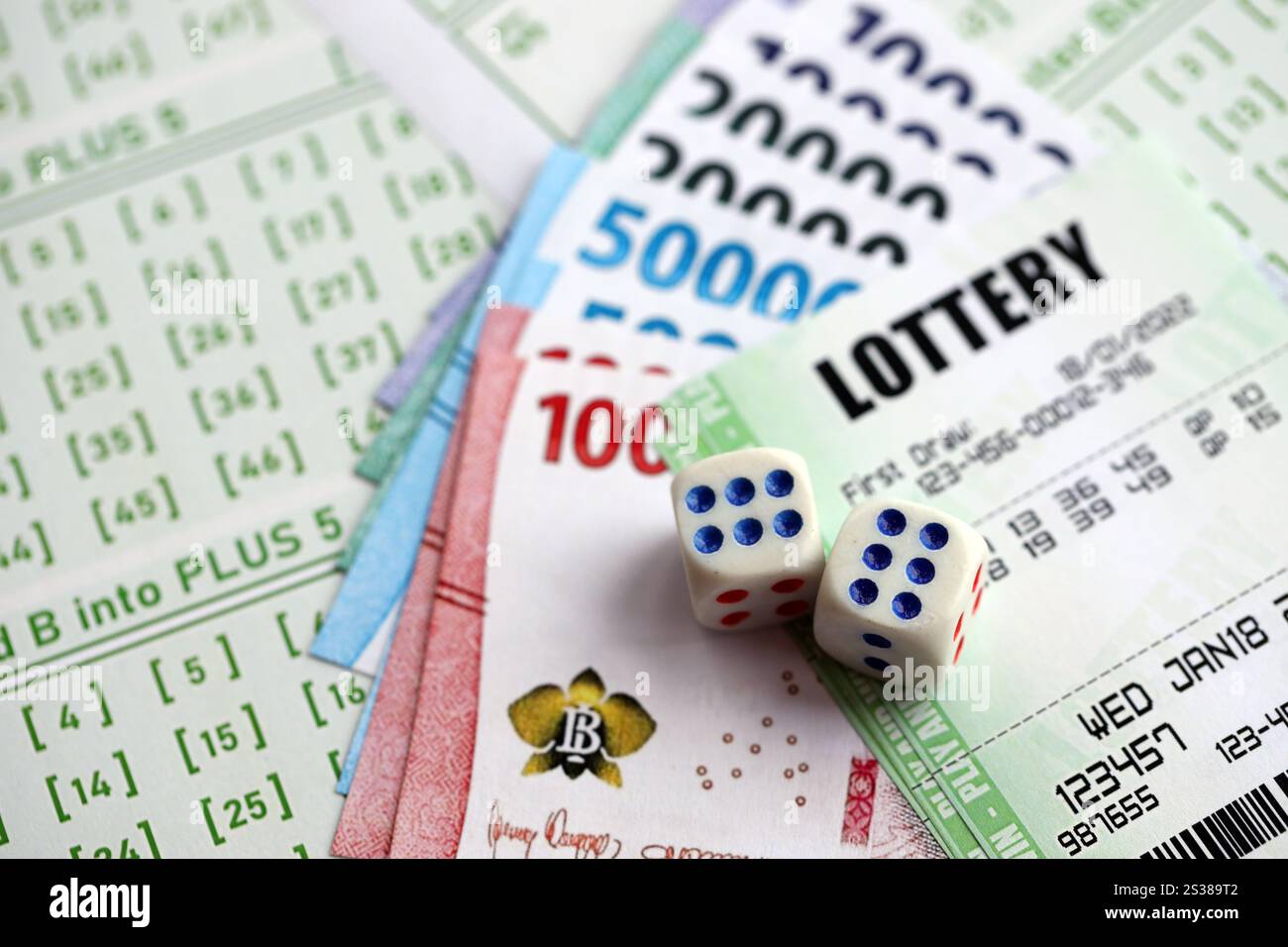 Green lottery tickets and indonesian money bills on blank with numbers ...