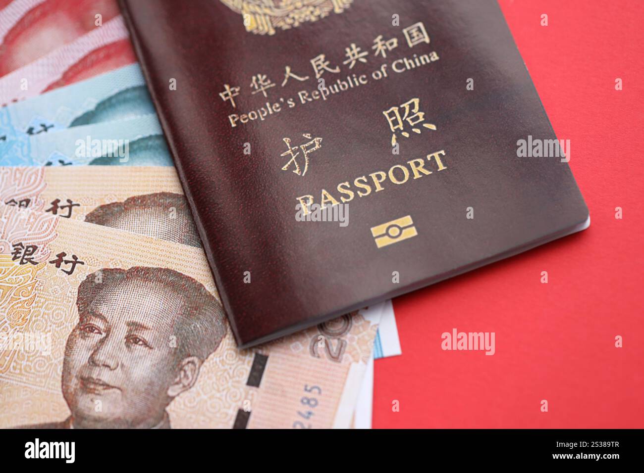Red passport of People Republic of China and chinese yuan money bills ...