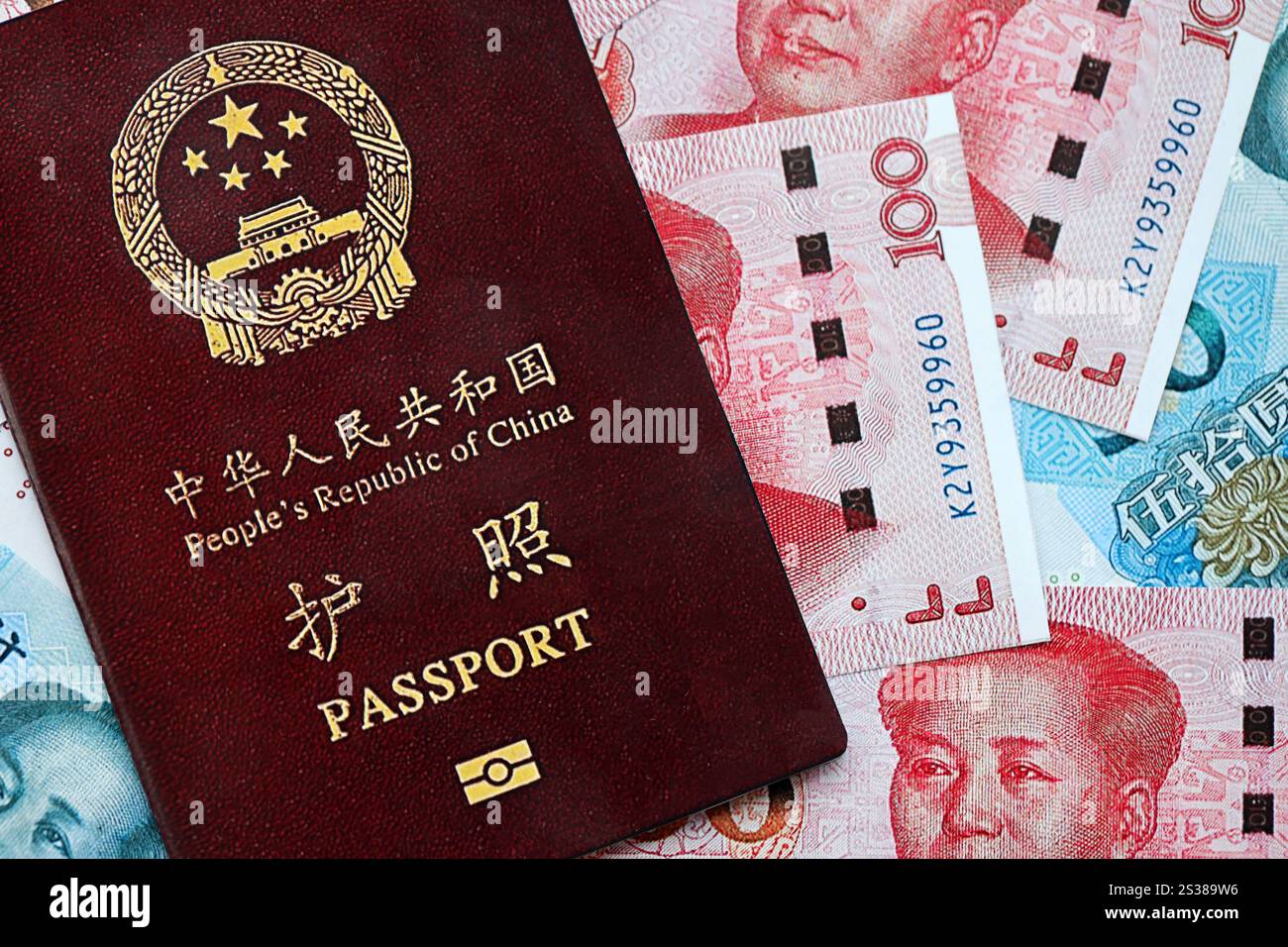 Red passport of People Republic of China and chinese yuan money bills ...