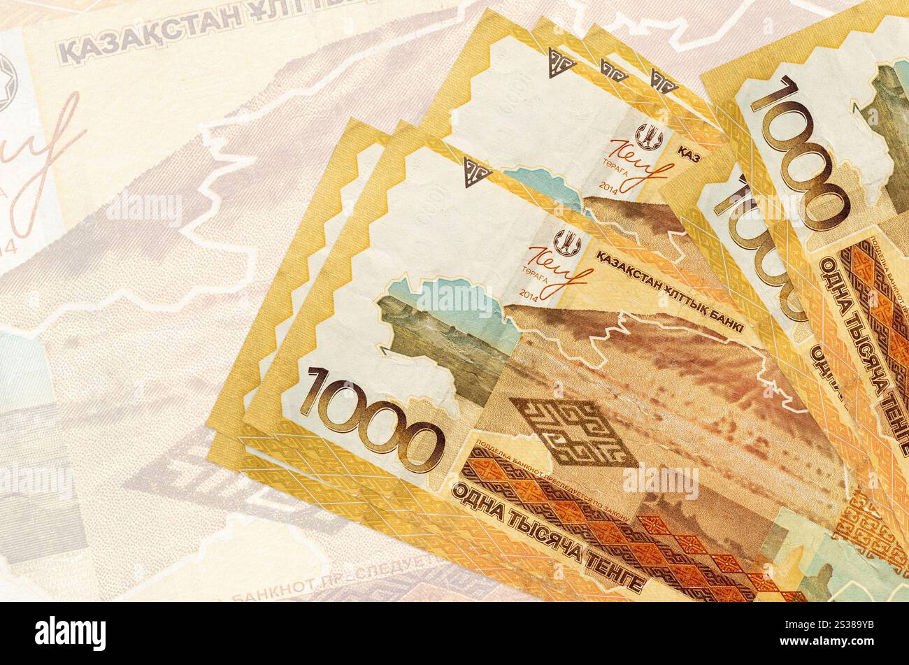 1000 Kazakhstani tenge bills lies in stack on background of big semi ...