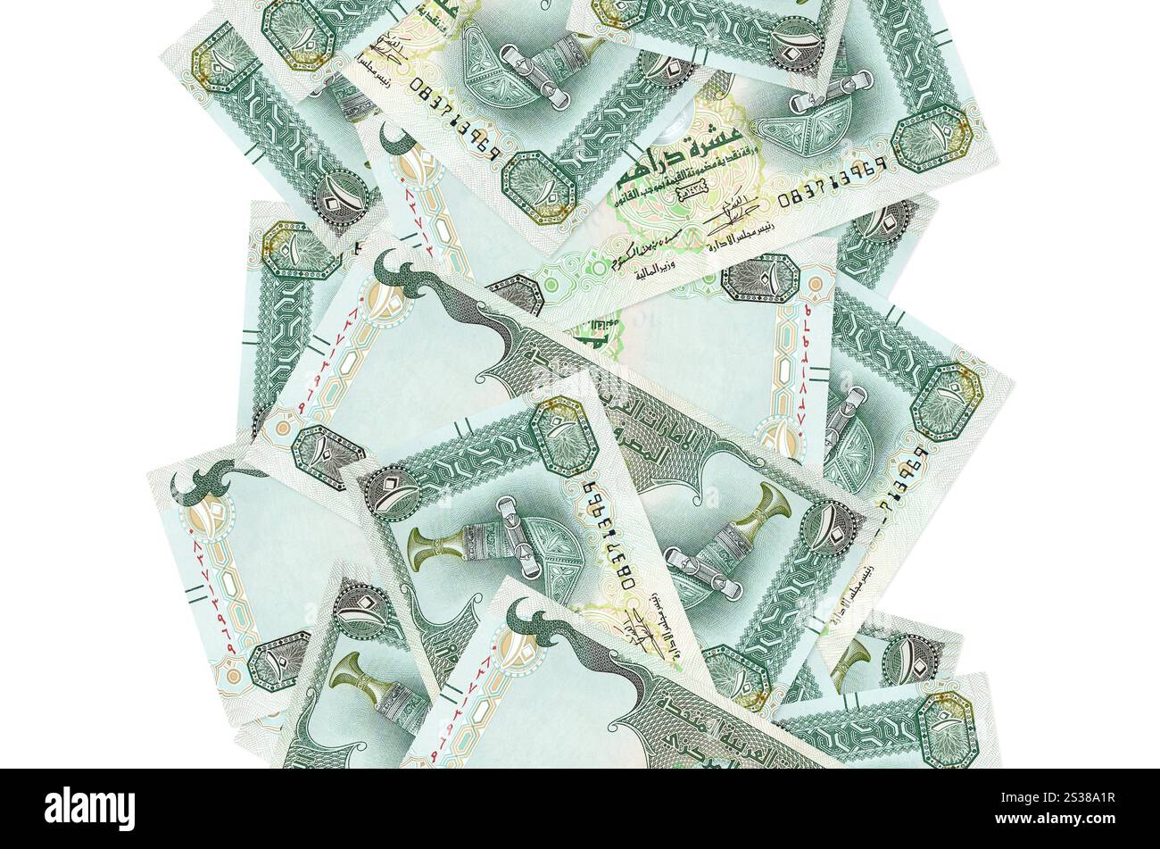 10 UAE dirhams bills flying down isolated on white. Many banknotes ...