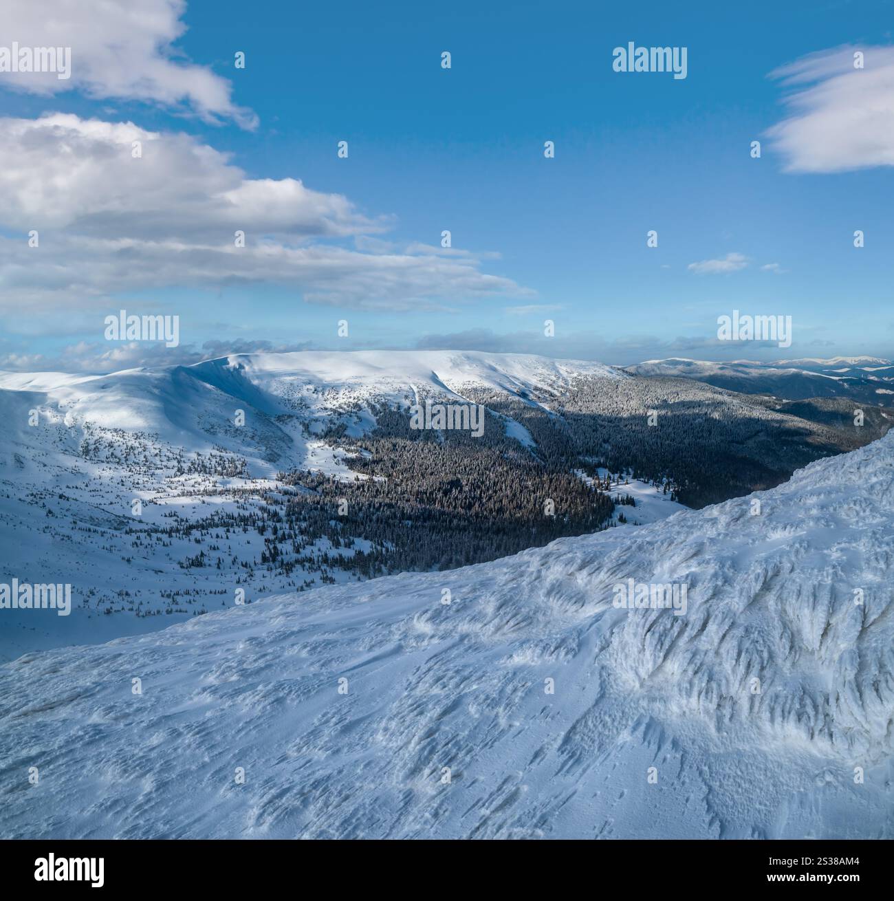 Snow and wind formed ice formations covered winter mountain plateau ...