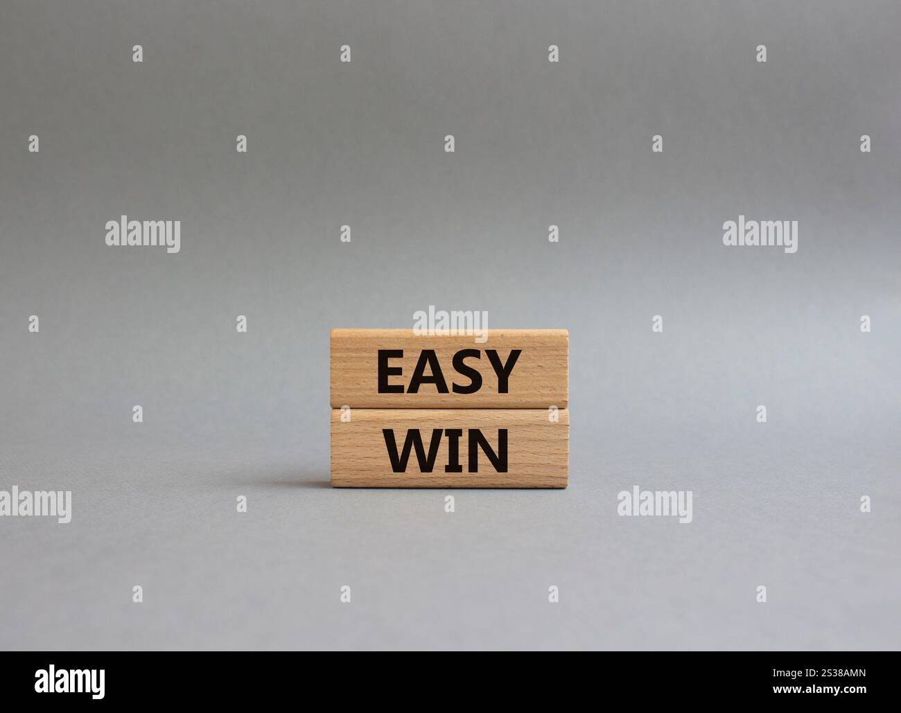 Easy win symbol. Wooden blocks with words Easy win. Beautiful grey ...