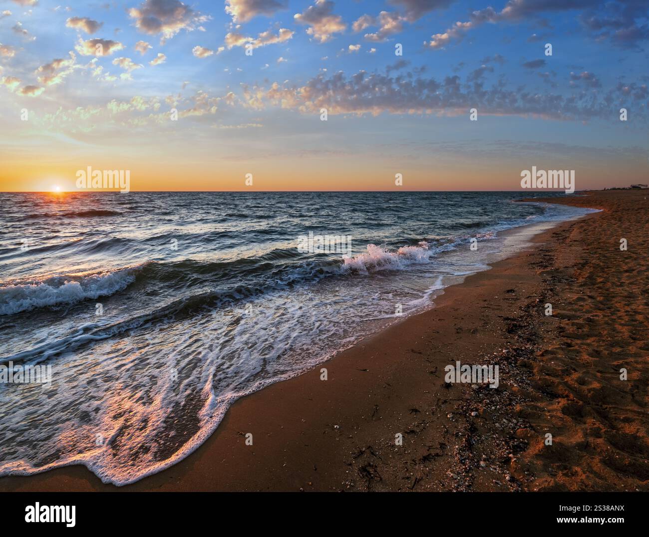 Colorful sea beach sunrise with clear morning sky and sun over horizon ...