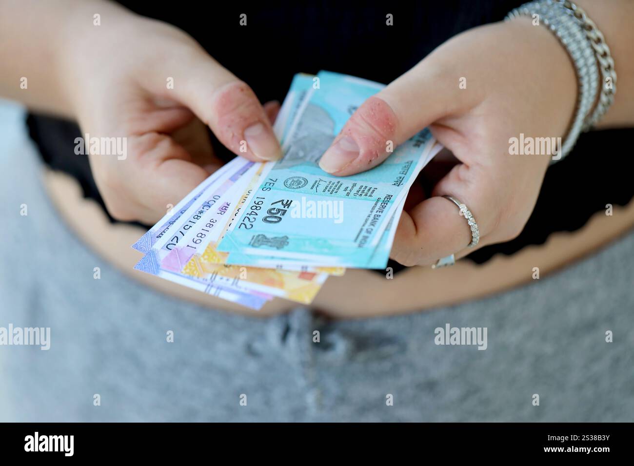 Rupees in hand hi-res stock photography and images - Alamy