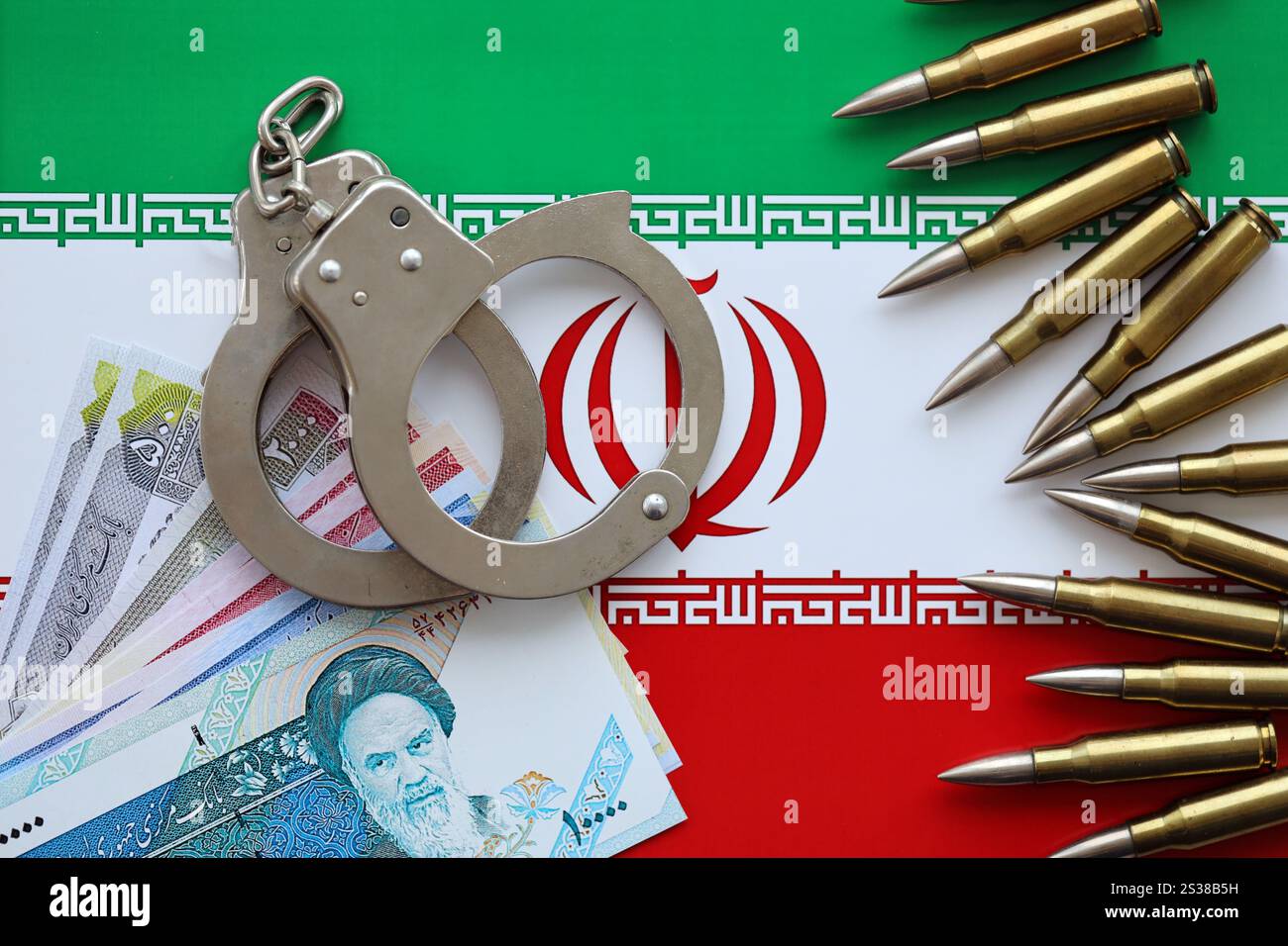 Iran flag and police handcuffs with iranian money bills rials. The ...
