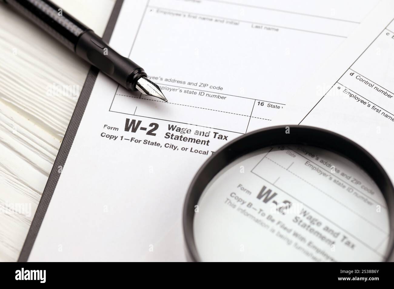 IRS Form W-2 Wage and Tax Statement blank on A4 tablet lies on office ...