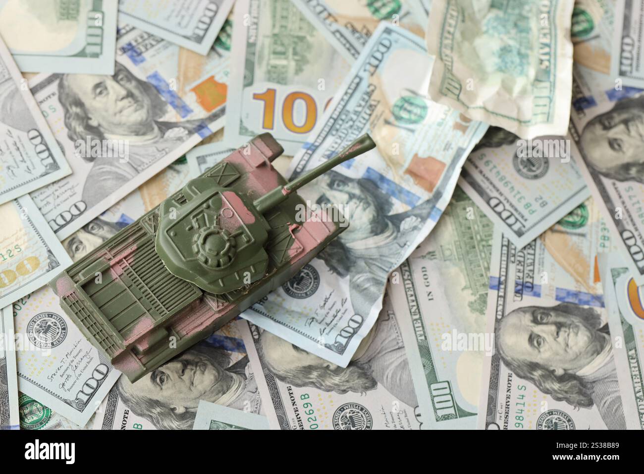 Tank on crumpled hundred dollar bills banknotes. Background of war ...