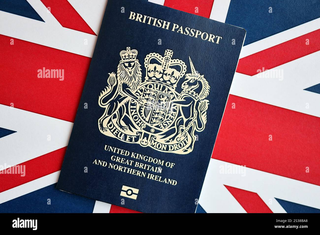 Blue British passport on national flag background close up. Tourism and ...