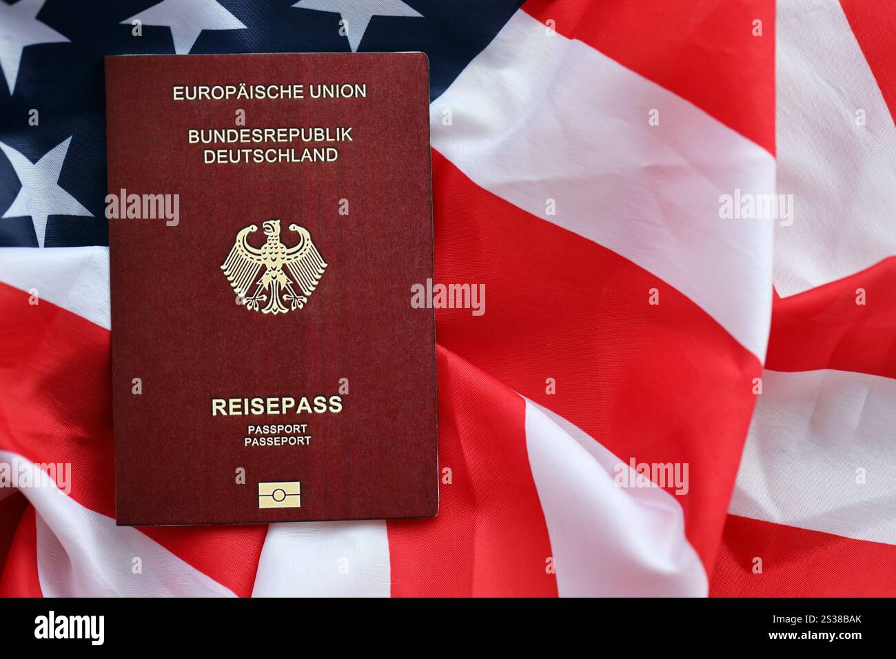 Red German passport of European Union on United States national flag ...