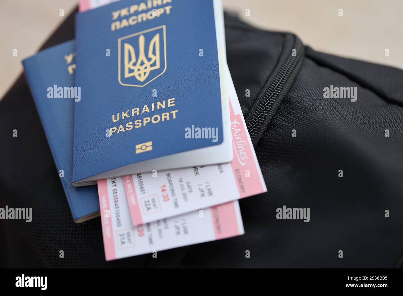 Two ukrainian biometrical passports with air flight tickets on black ...