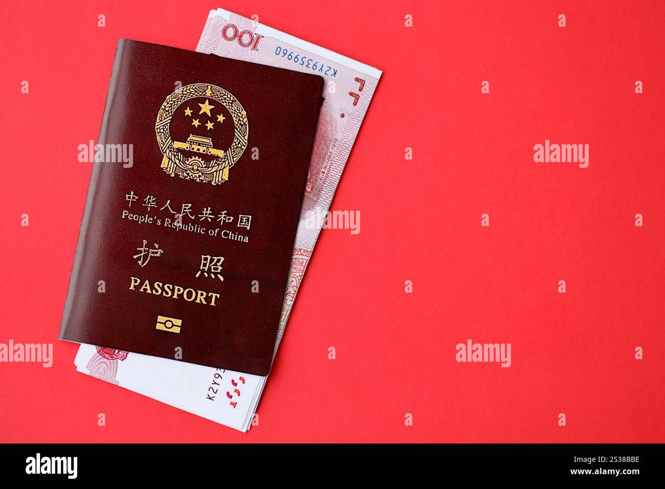 Red passport of People Republic of China and chinese yuan money bills ...