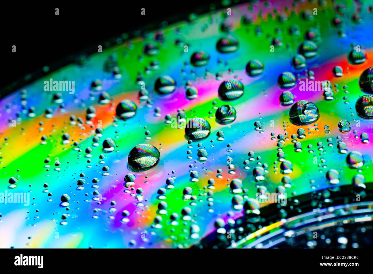 Abstract macro photo of extremely colorful water drops on a dvd surface ...