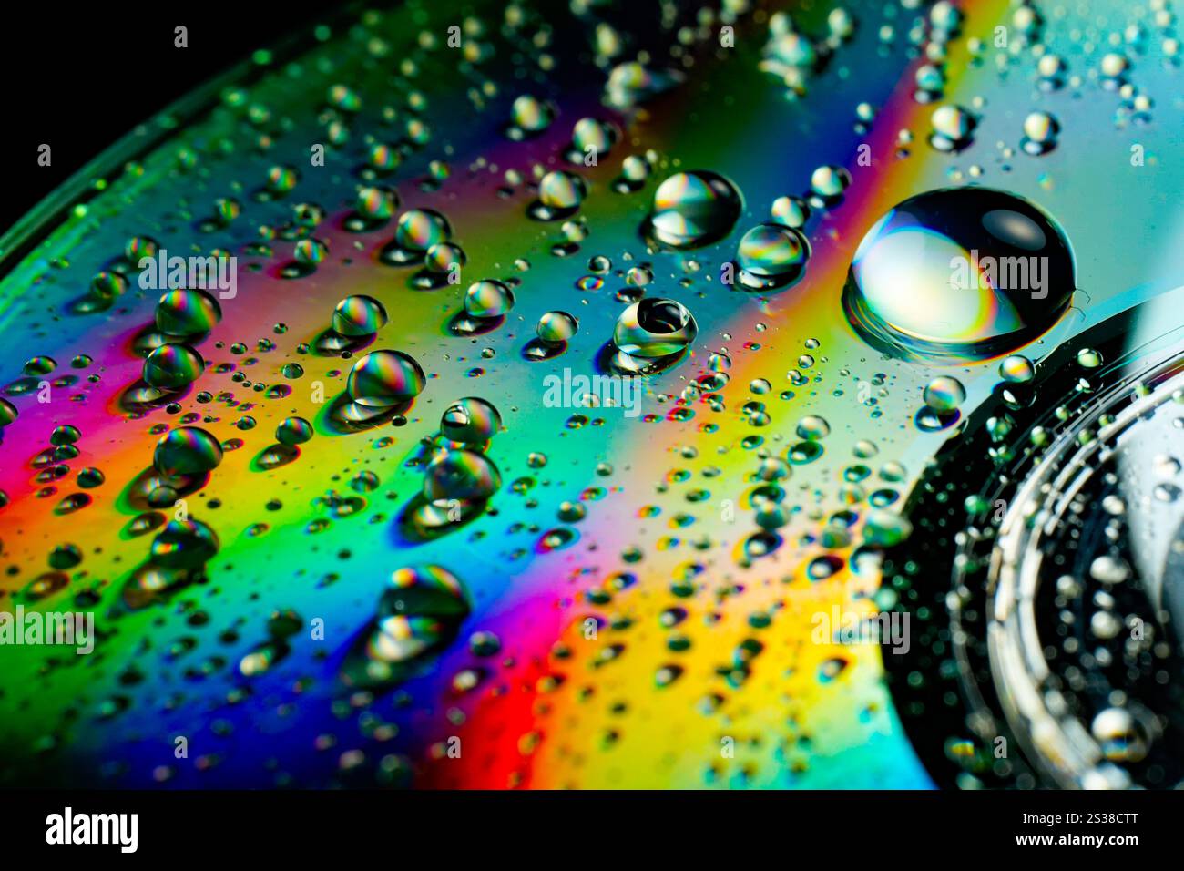 Abstract macro photo of extremely colorful water drops on a dvd surface ...