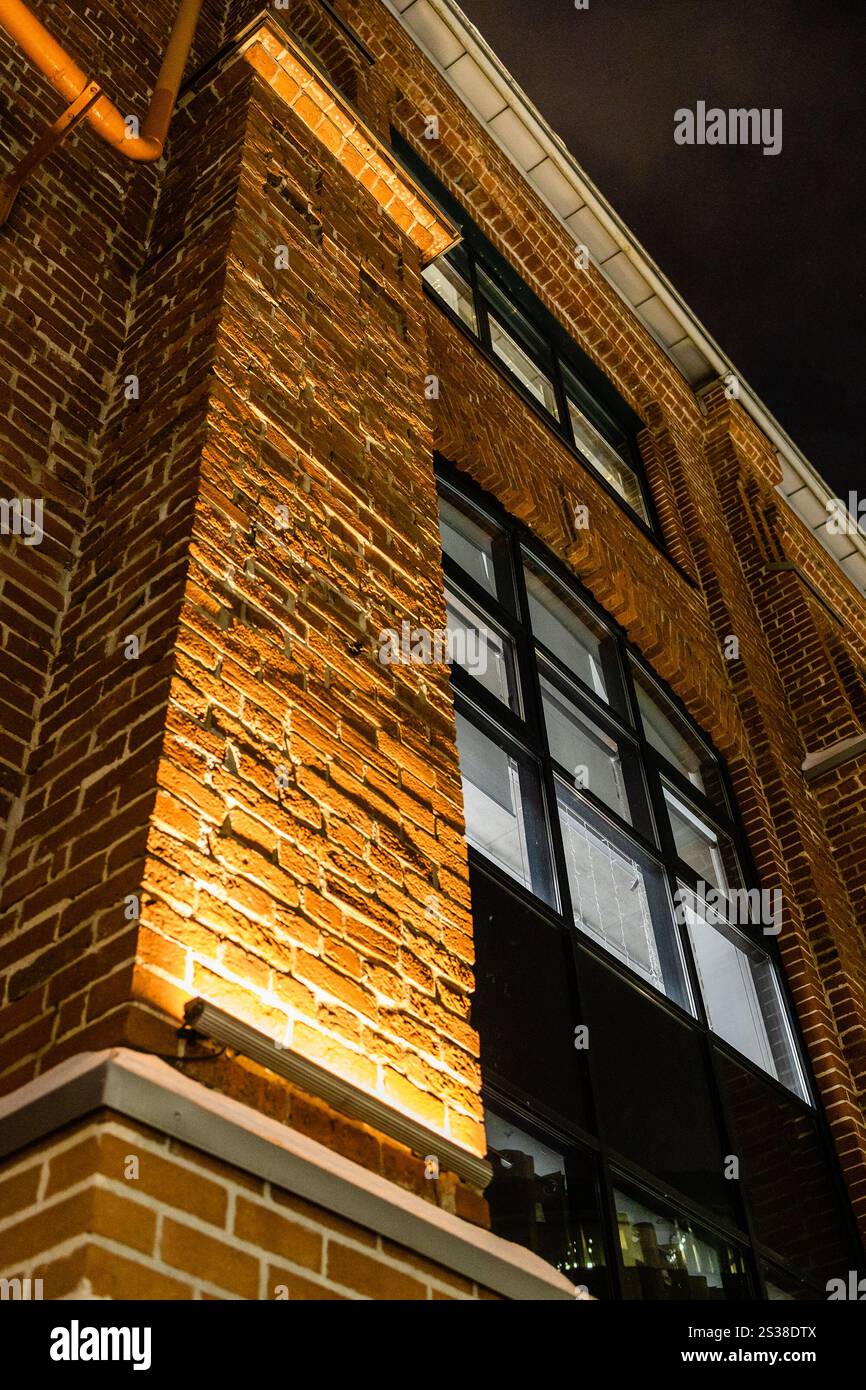 brick facade of renovated old factory building on night in Moscow city ...