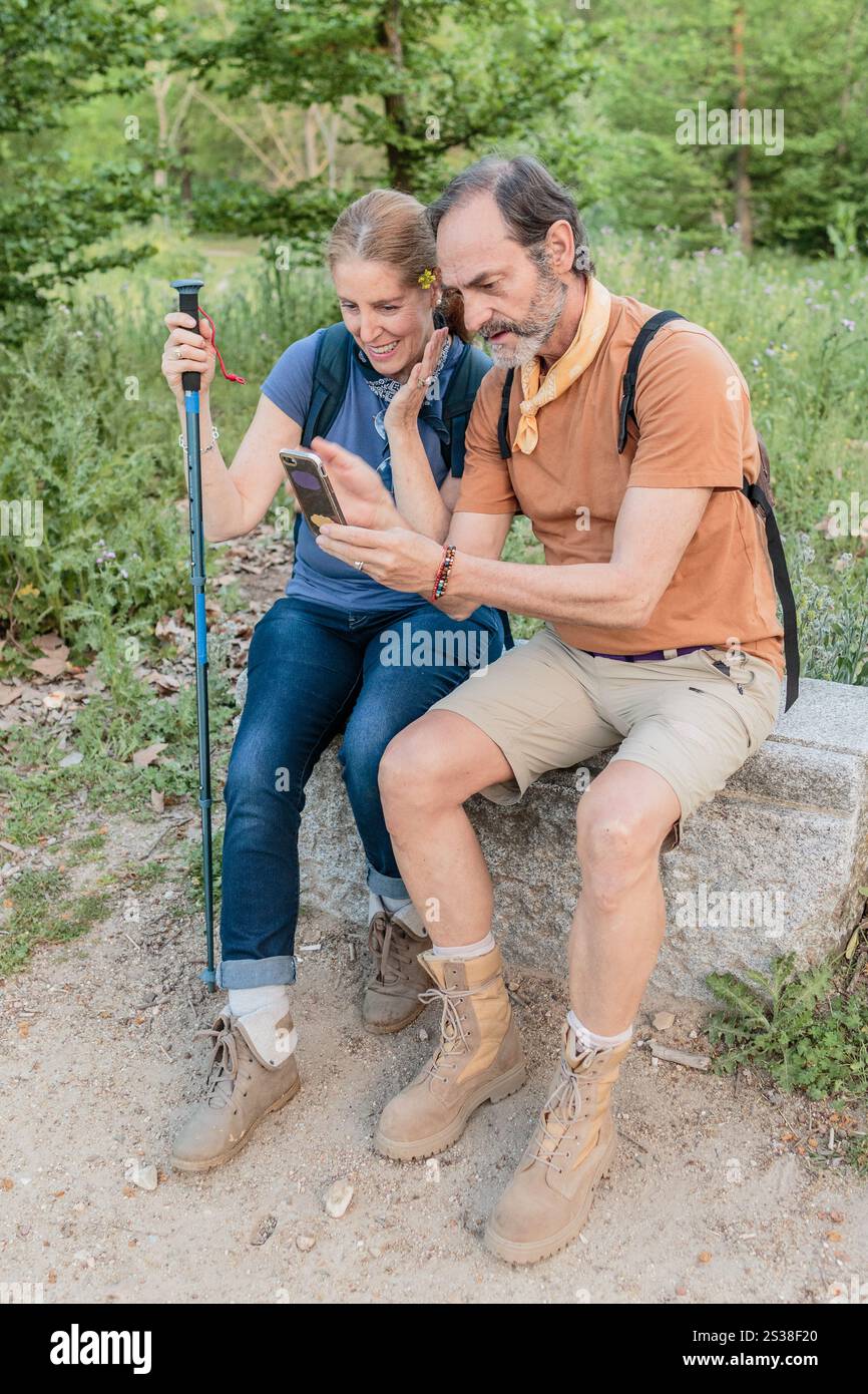 Hikers using smartphone during trekking in madrid, spain Stock Photo - Alamy