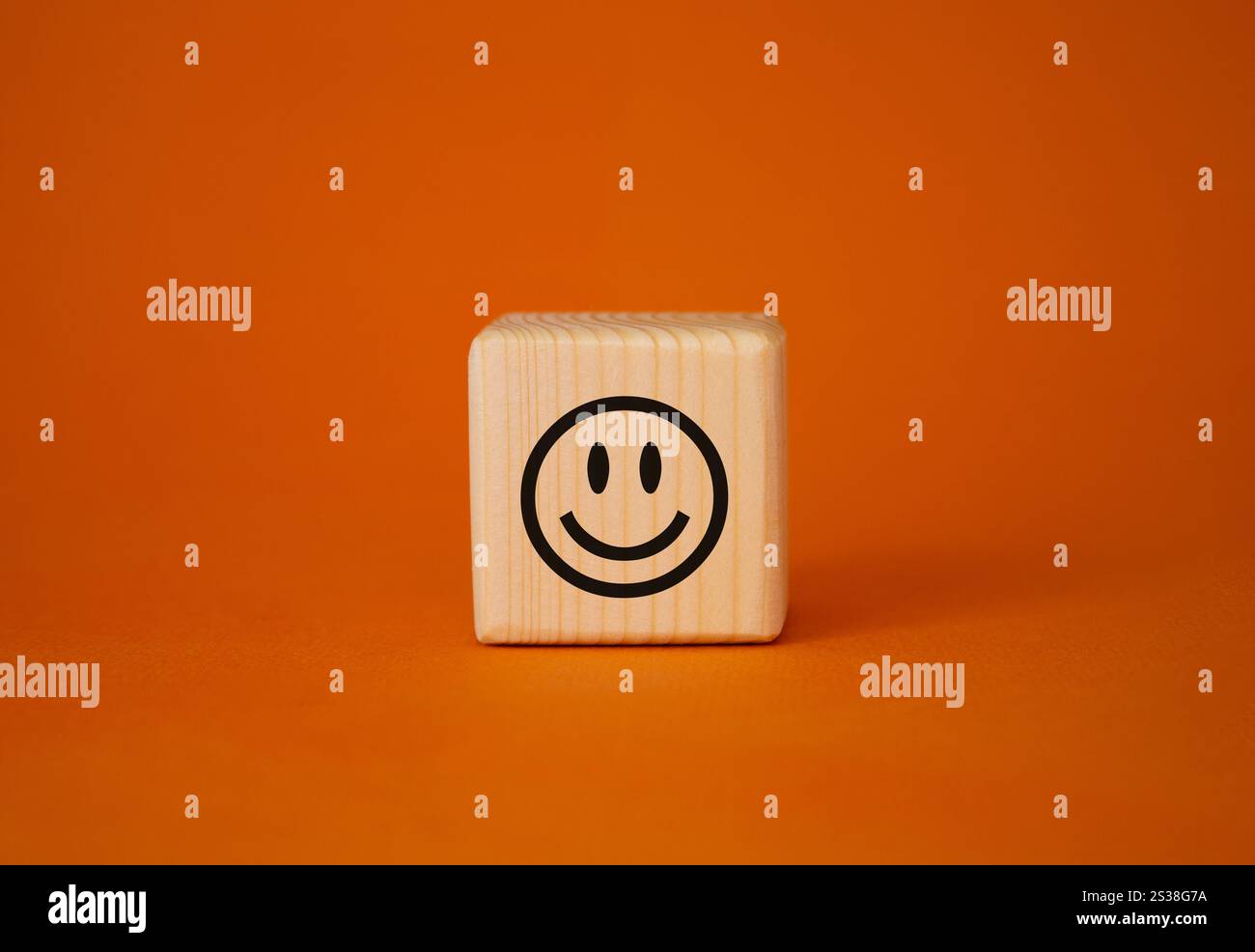 Happy smile symbol. Happy smile on wooden cubes. Beautiful orange ...
