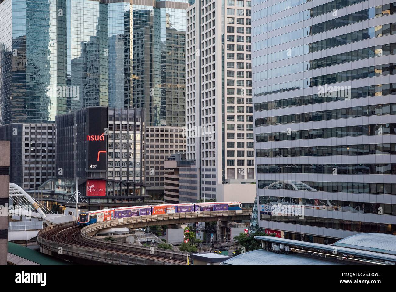 a skytrain with high Buildings in Silom in the city of Bangkok in ...