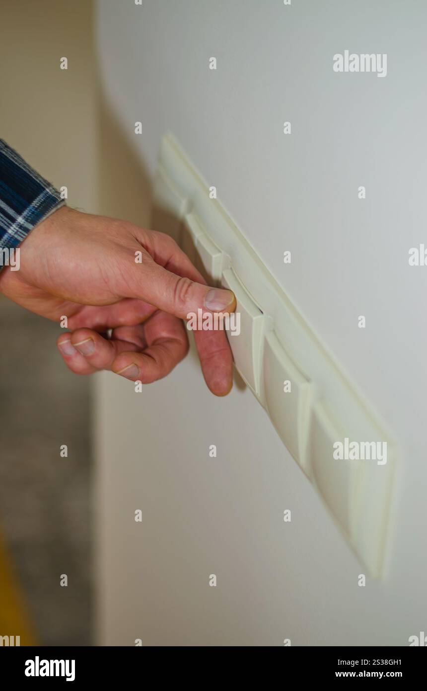 Mans hand switch on kitchen hi-res stock photography and images - Alamy