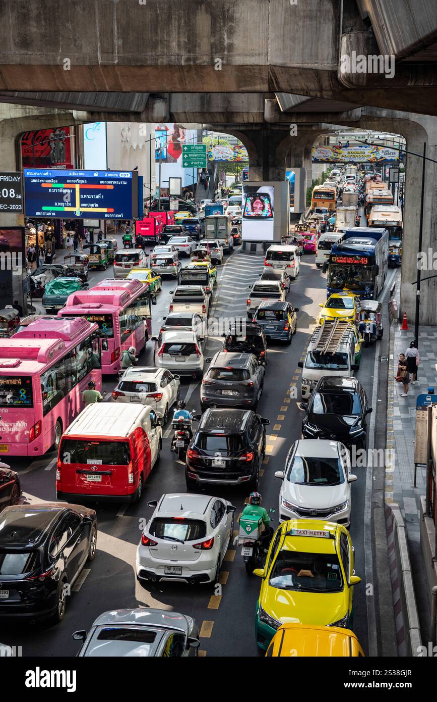 Traffic with cars on the road at the Siam Square in the city of Bangkok ...