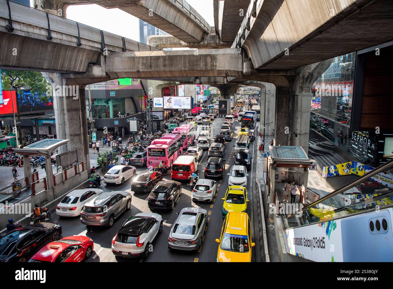 Traffic with cars on the road at the Siam Square in the city of Bangkok ...