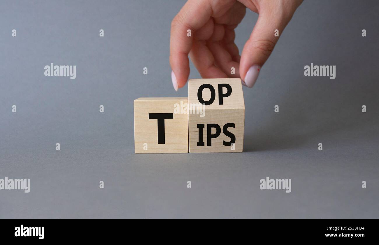 Top Tips symbol. Businessman hand Turnes cubes with words Top Tips ...