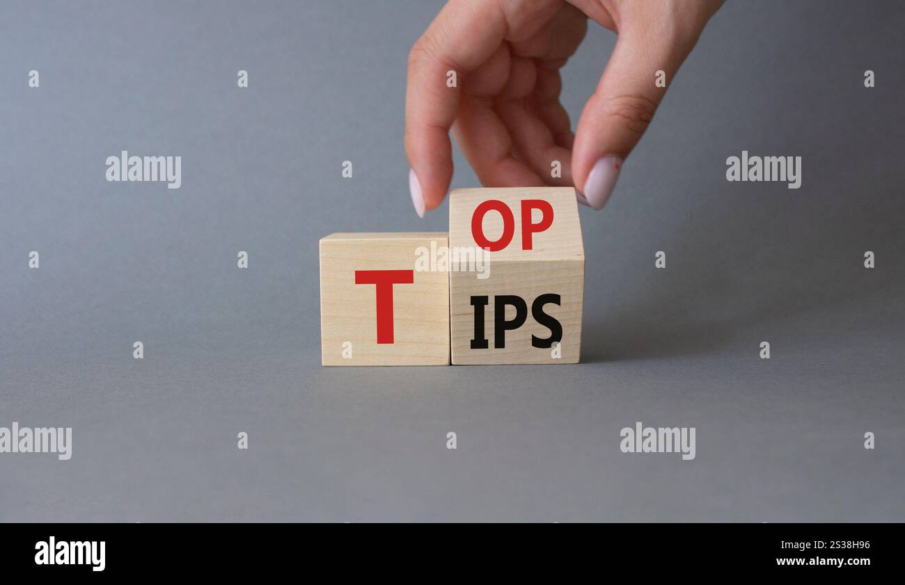Top Tips symbol. Businessman hand Turnes cubes with words Top Tips ...
