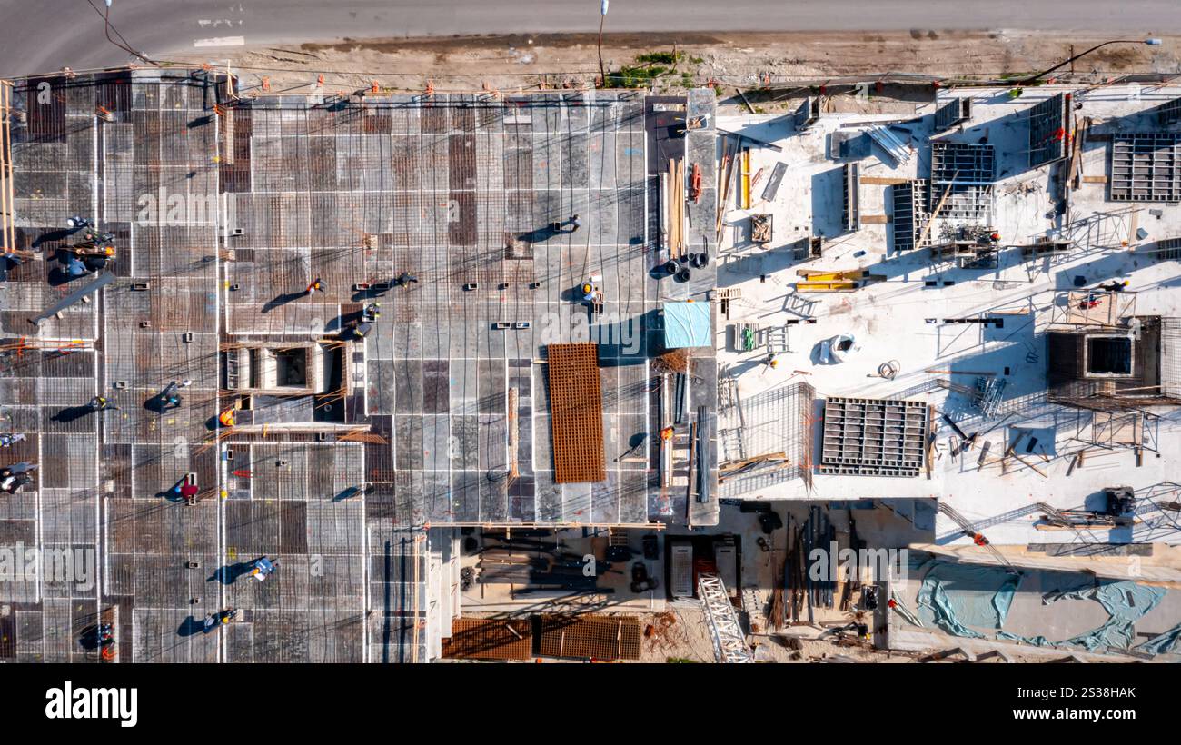 Above top view construction workers, masons are assembly, quadratic ...