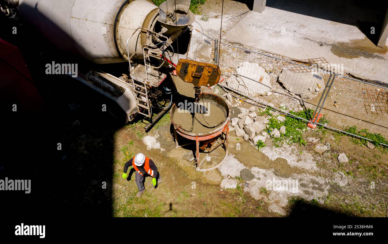 Above view on process of transshipment fresh concrete from mixer truck ...