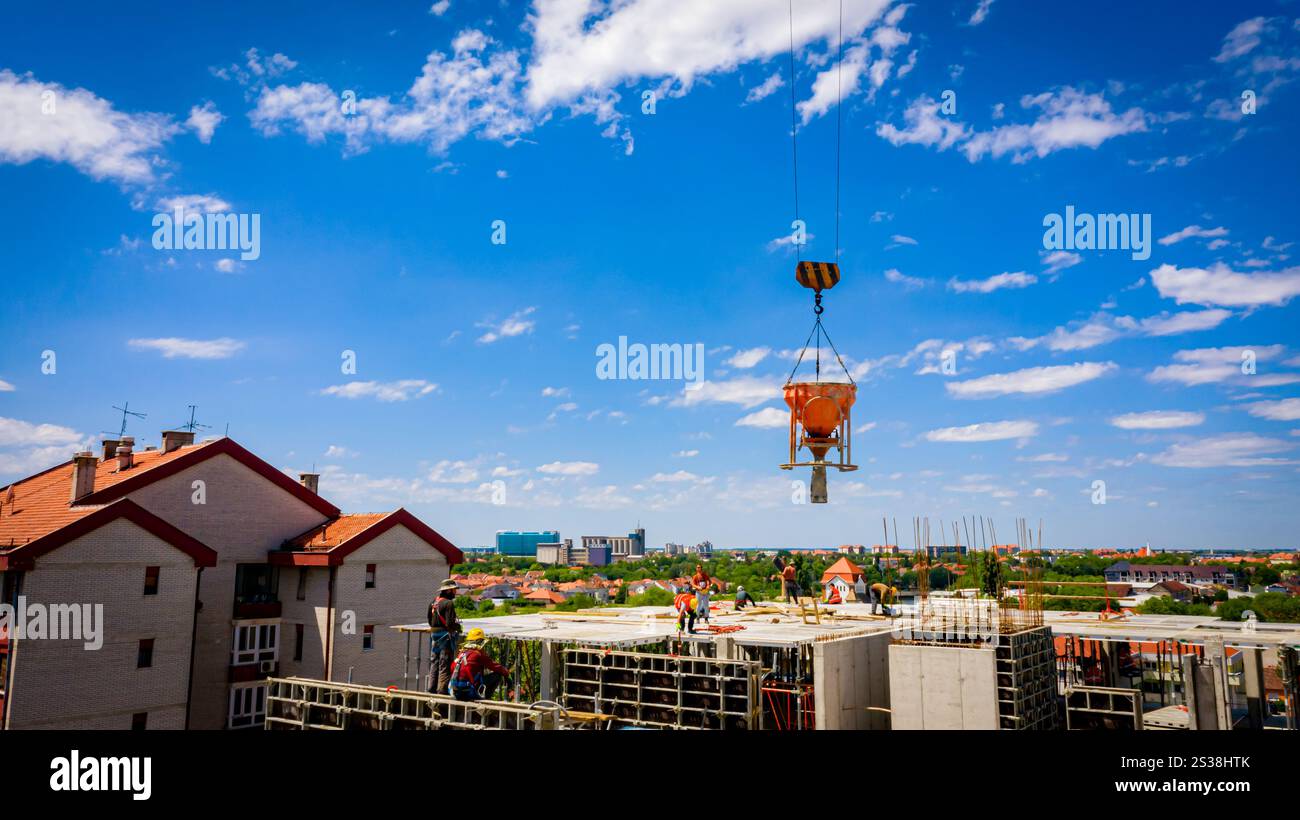 Above view on tower crane as carry cone tank, conical metal bucket to ...