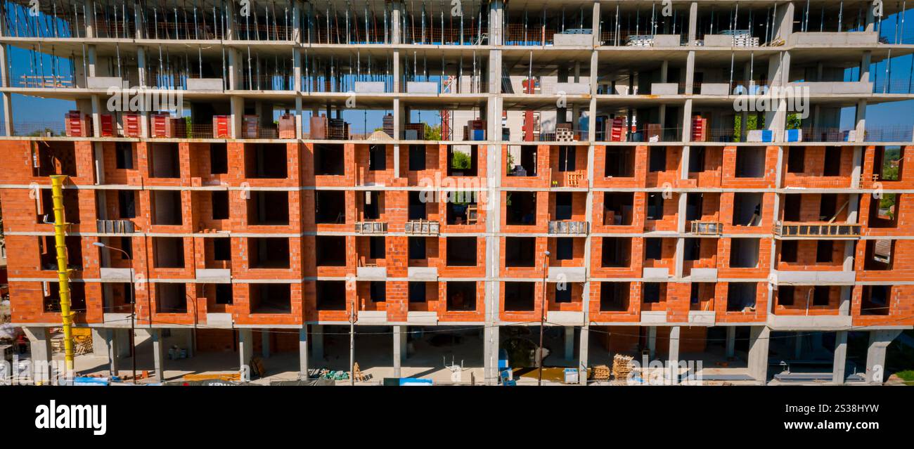 Above view on concrete skeleton of new unfinished large storey building ...
