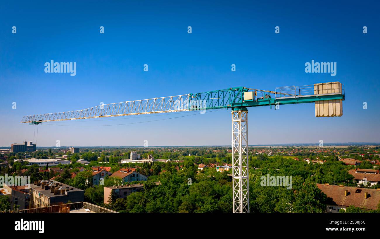 Tower crane with counterbalance made of several linked concrete weights ...
