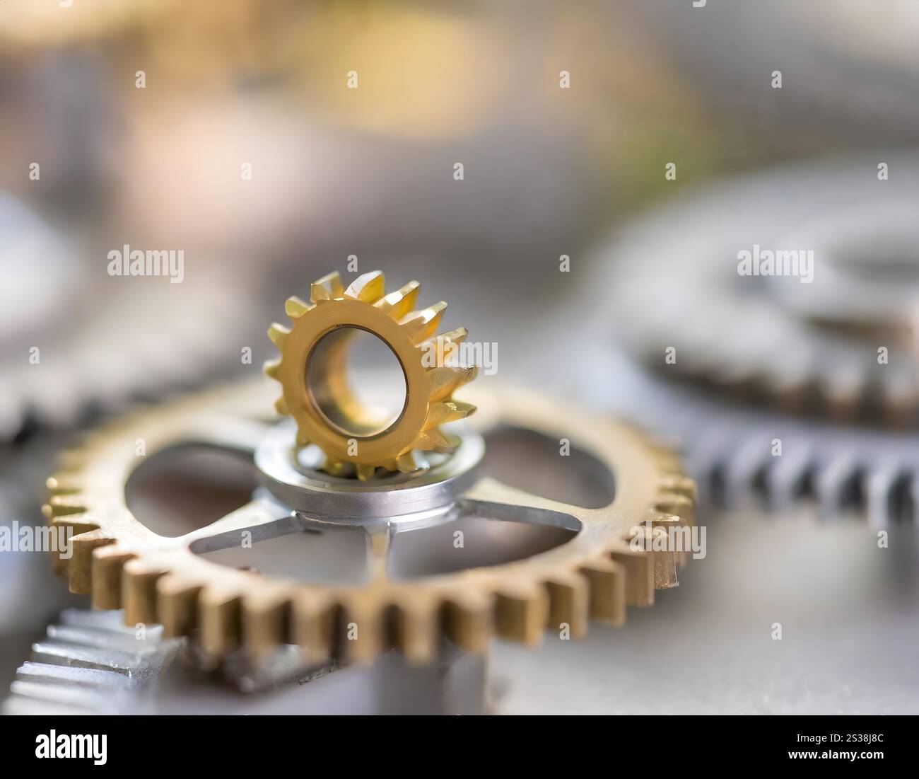 A detailed view of a metal gear wheel showing intricate teeth and gears ...