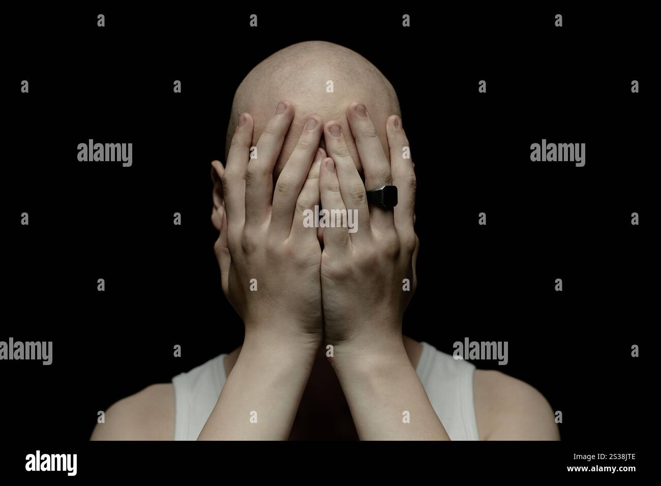 Portrait of pale bald man covering face with hands trying to hide from ...