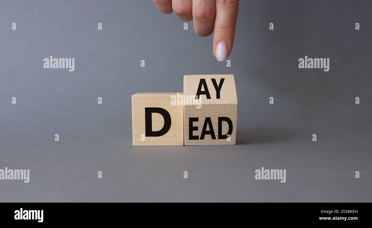 Day of the Dead symbol. Businessman hand points at turned wooden cubes ...