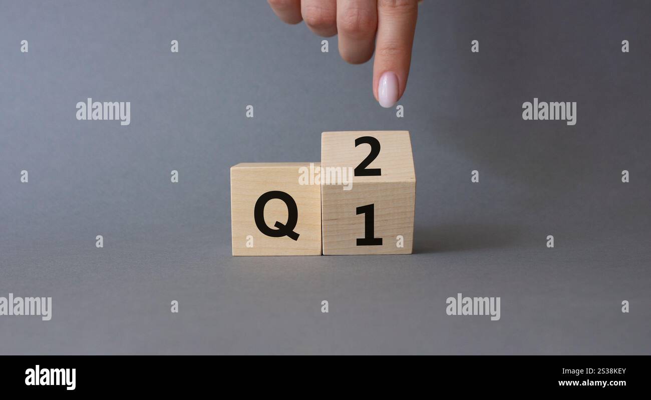 From 1st Quarter to 2nd symbol. Businessman hand points at turned ...