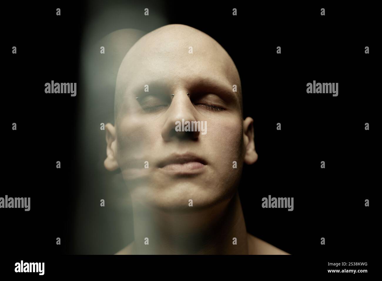 Close up portrait of bald pale man with bridge piercing addressing his ...