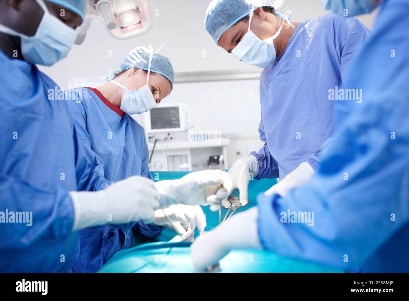Surgery, hospital and group of doctors in operating room for patient ...